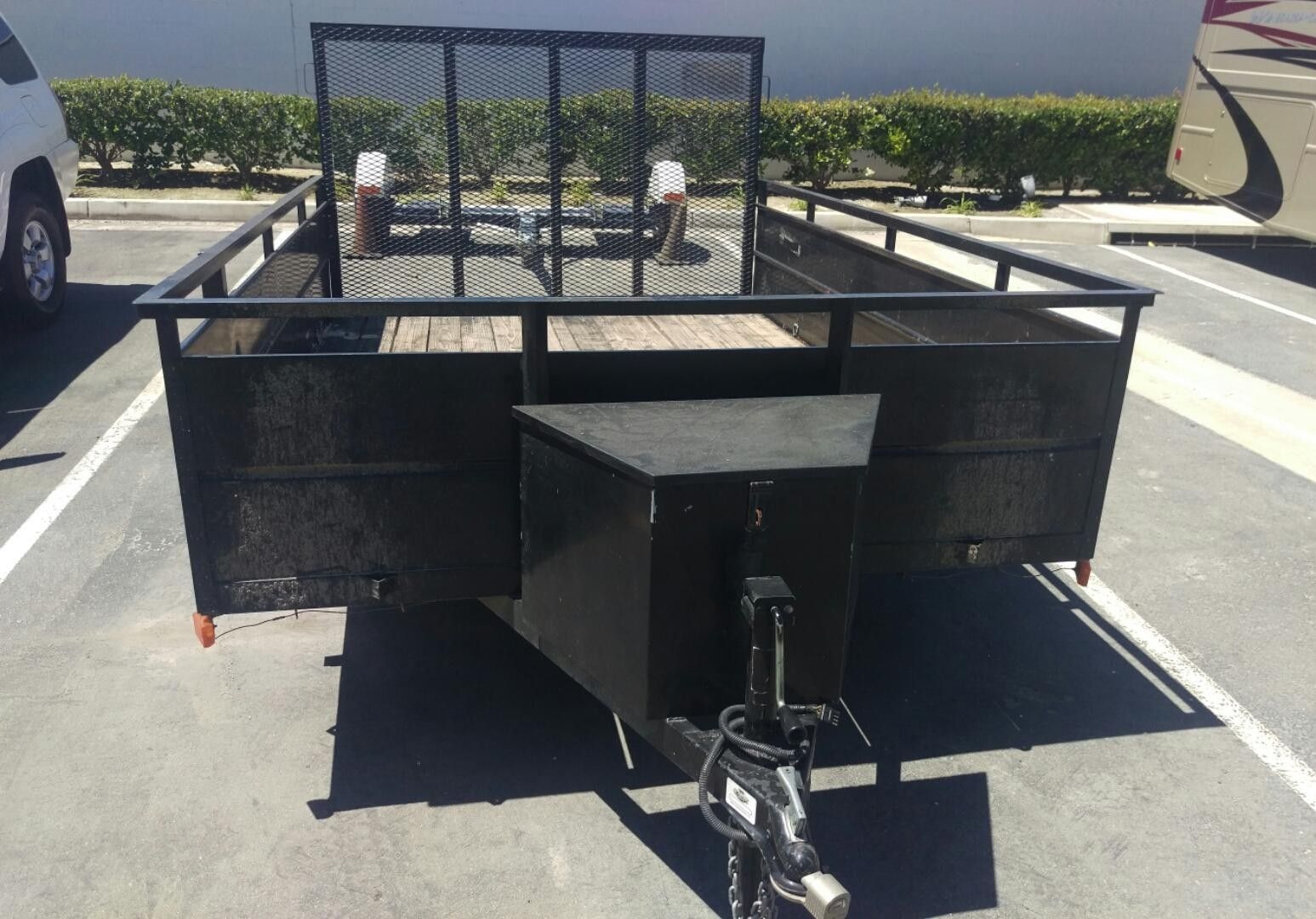 Open utility trailer with mesh ramp gate. 7' wide x 10' long inside ...