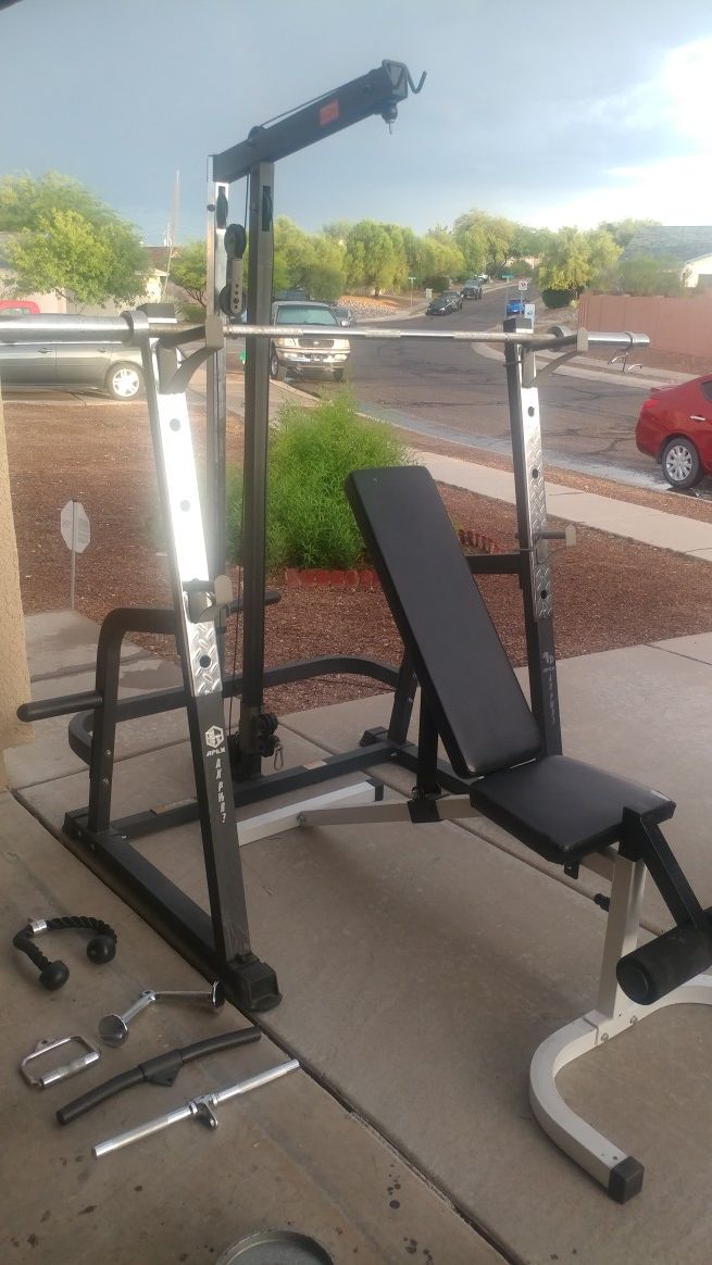 Weight bench with squat rack, pulley system, Olympic barbell and ...
